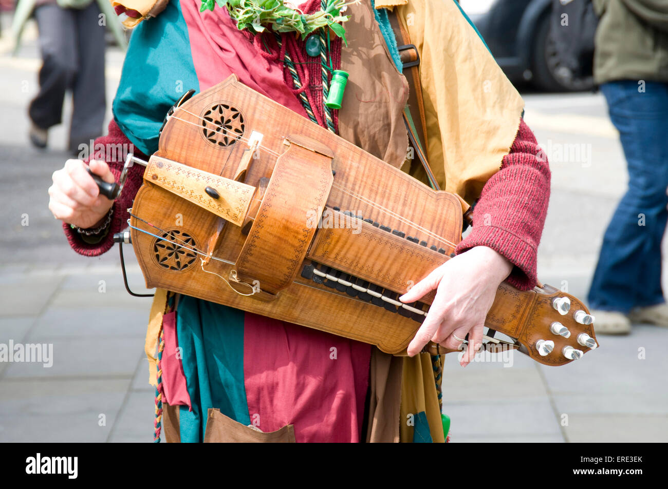 Woman playing a hurdy gurdy in fancy costume taking part in the St ...