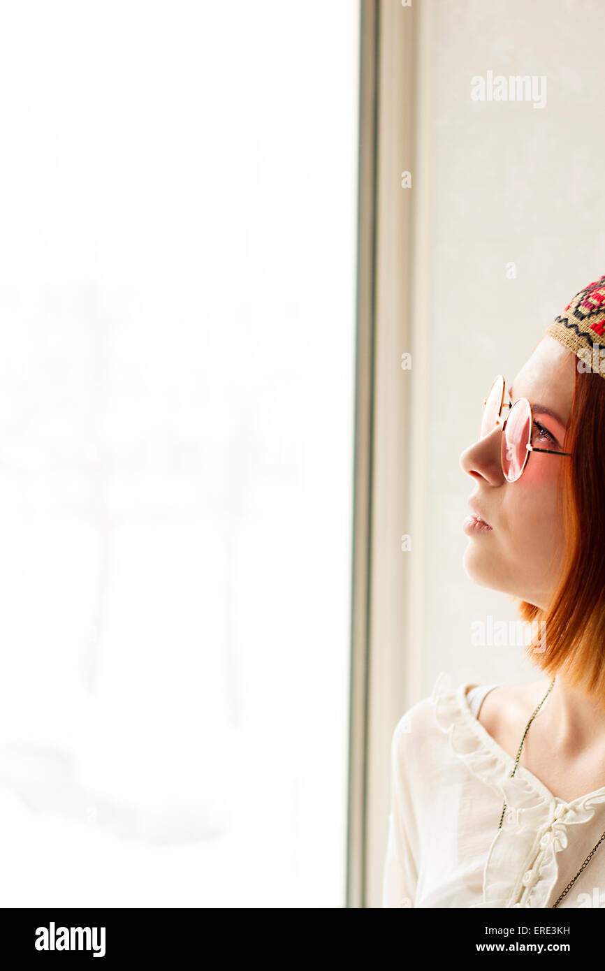 Caucasian woman wearing sunglasses near window Stock Photo - Alamy