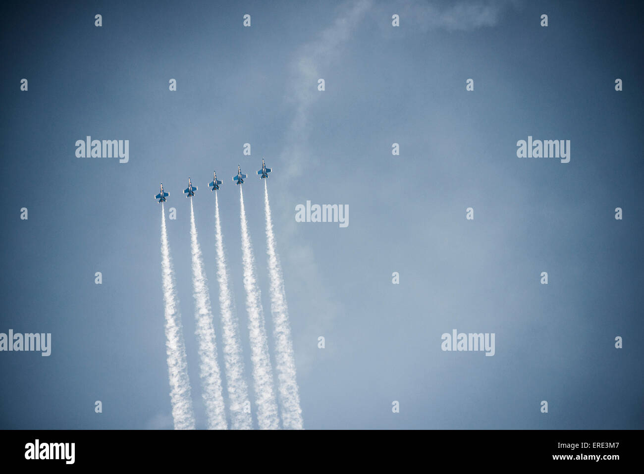 Jets flying in formation in cloudy blue sky Stock Photo - Alamy
