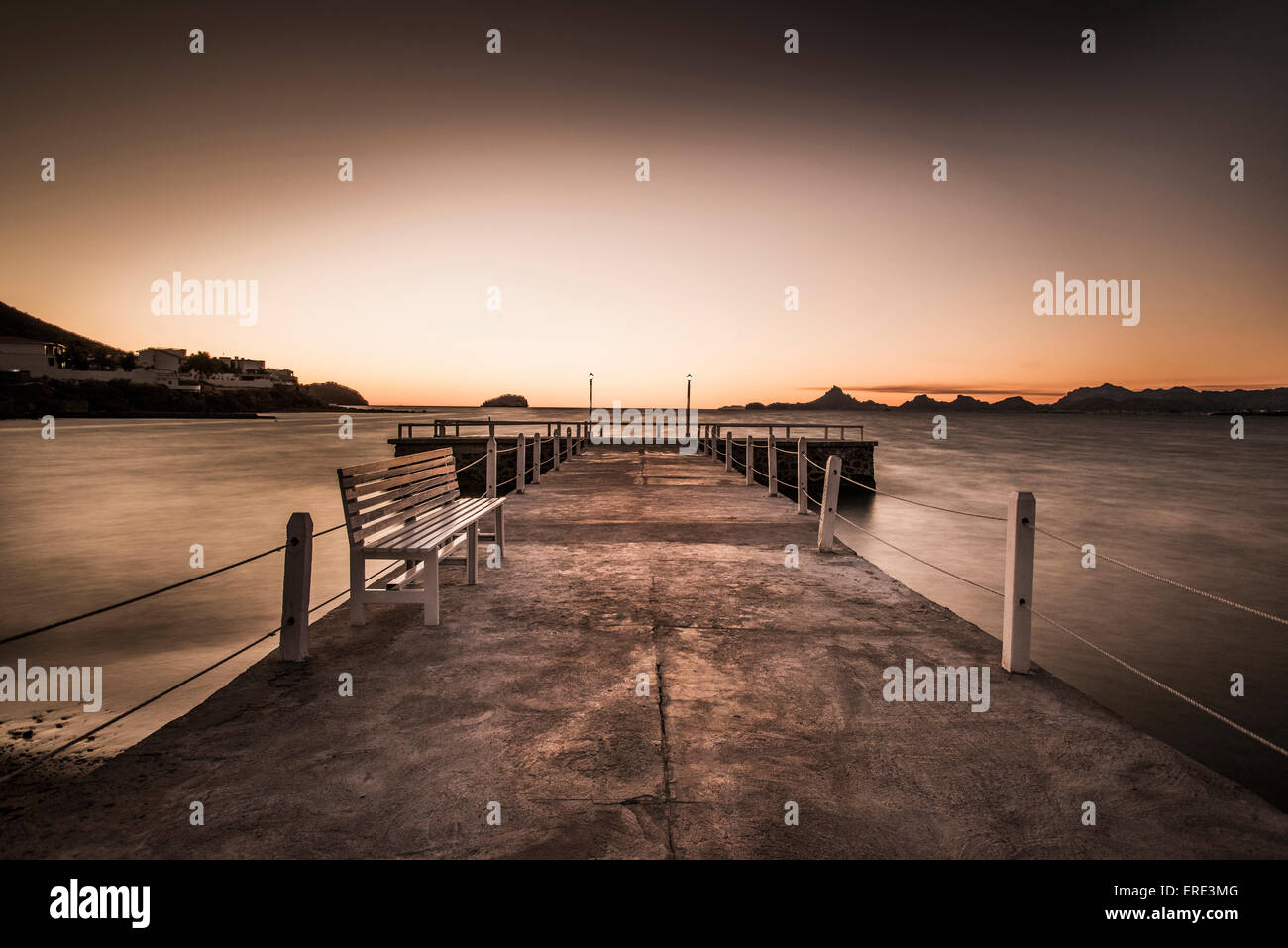Stone walkway and ocean waves under sunset sky Stock Photo - Alamy