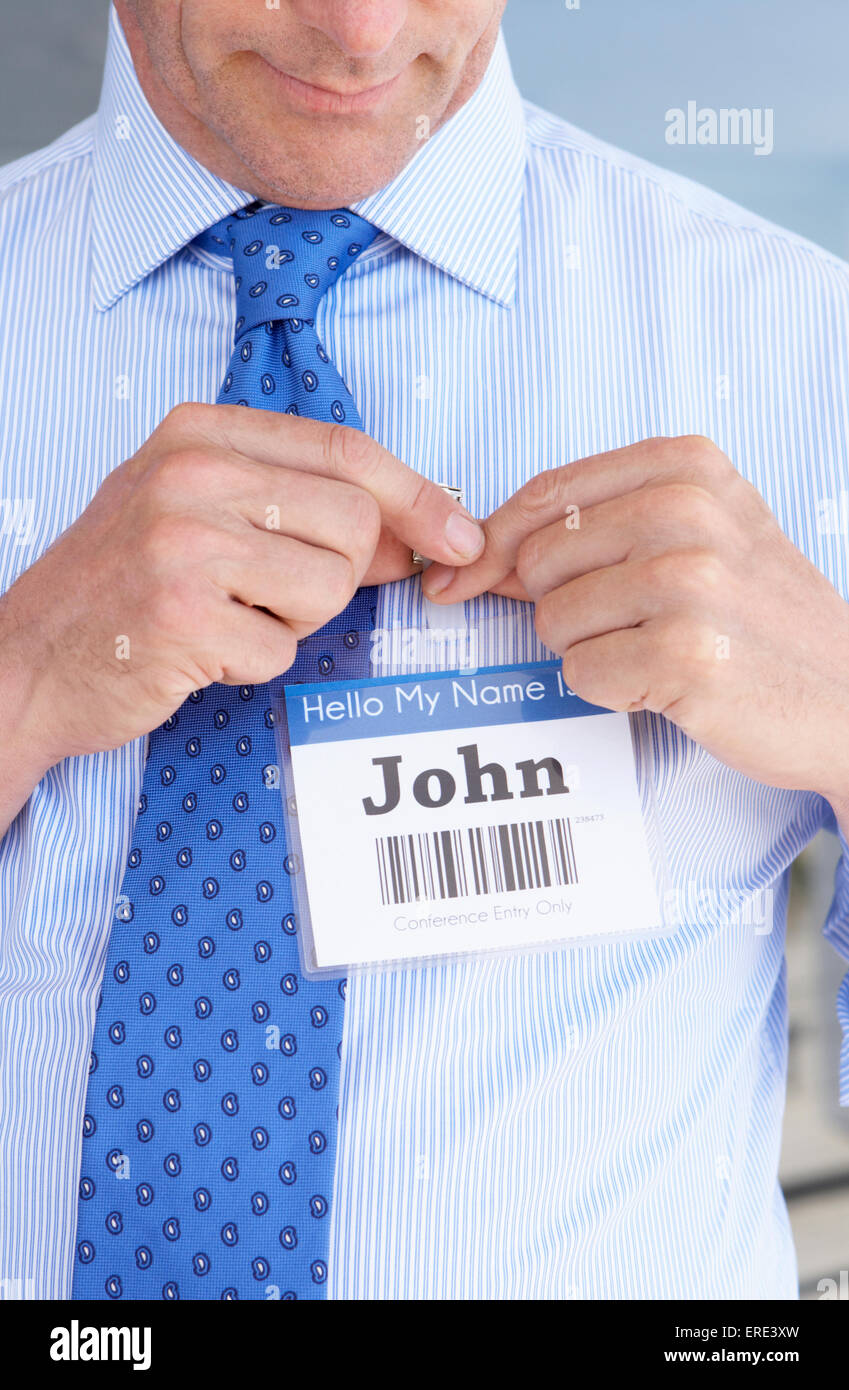 Detail Of Delegate Pinning On Name Badge At Conference Stock Photo - Alamy