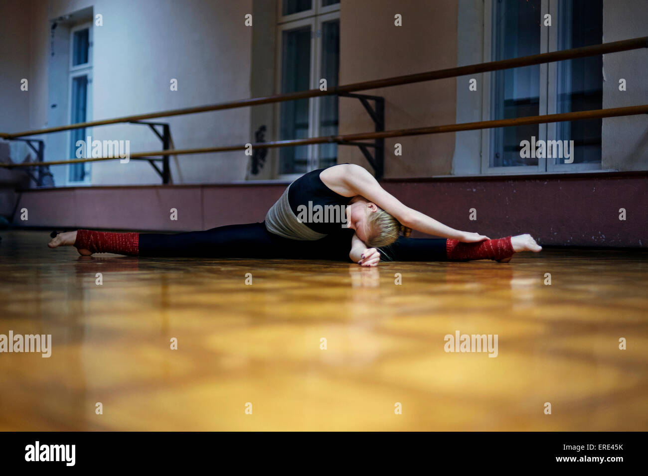 Caucasian dancer stretching doing splits on studio floor Stock Photo ...