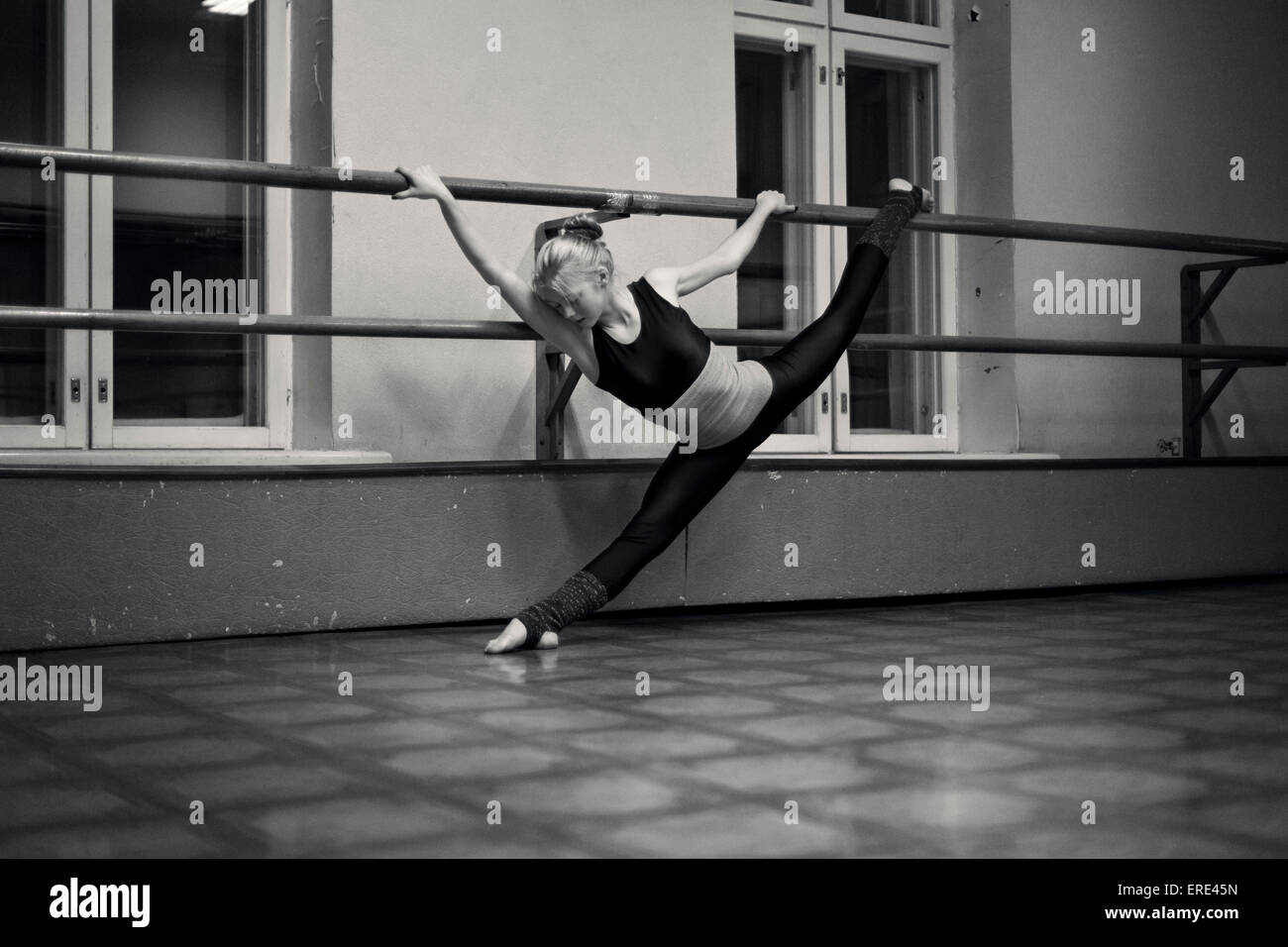 Caucasian dancer doing splits on barre in studio Stock Photo - Alamy