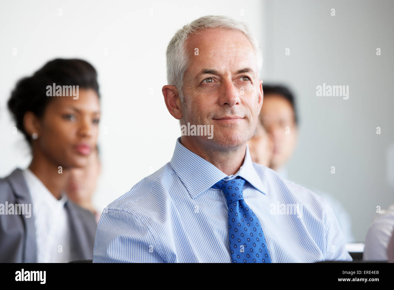 Group Of Delegates Listening To Presentation At Conference Stock Photo ...