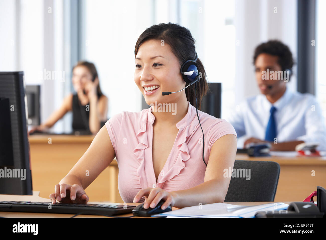 Friendly Customer Service Agent In Call Centre Stock Photo - Alamy