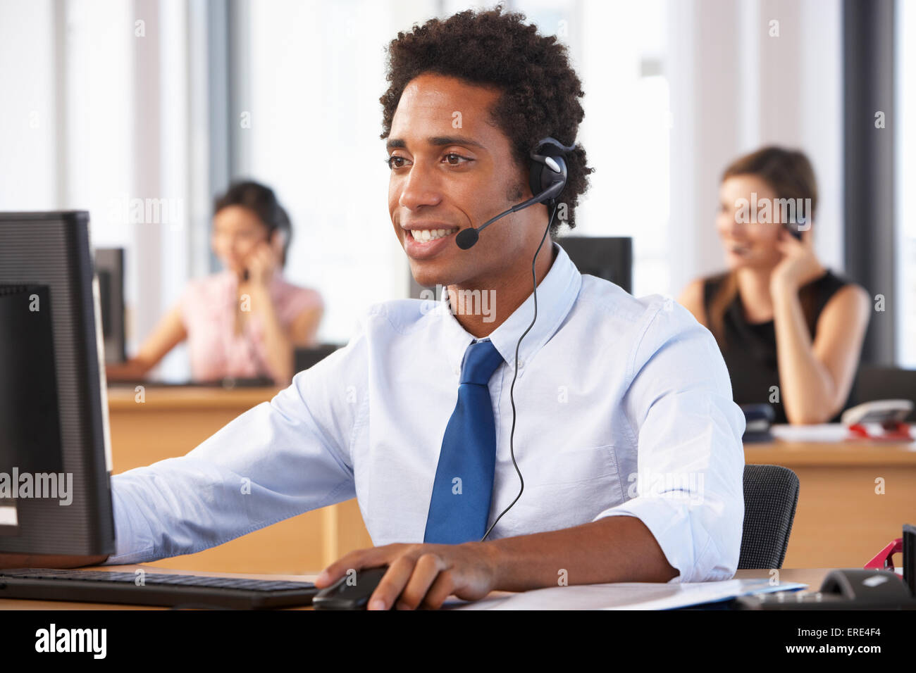 Friendly Customer Service Agent In Call Centre Stock Photo - Alamy