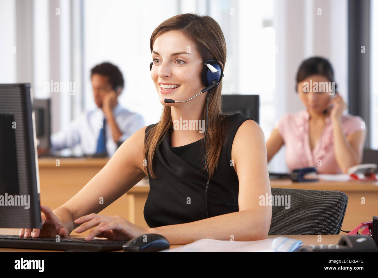 Friendly Customer Service Agent In Call Centre Stock Photo - Alamy