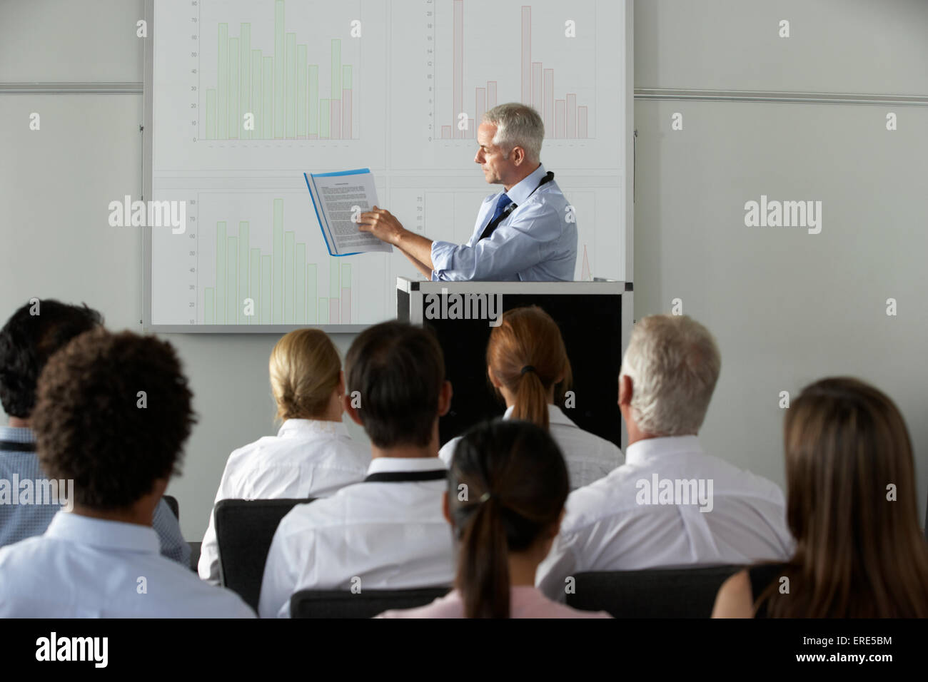 Middle Aged Businessman Delivering Presentation At Conference Stock Photo - Alamy
