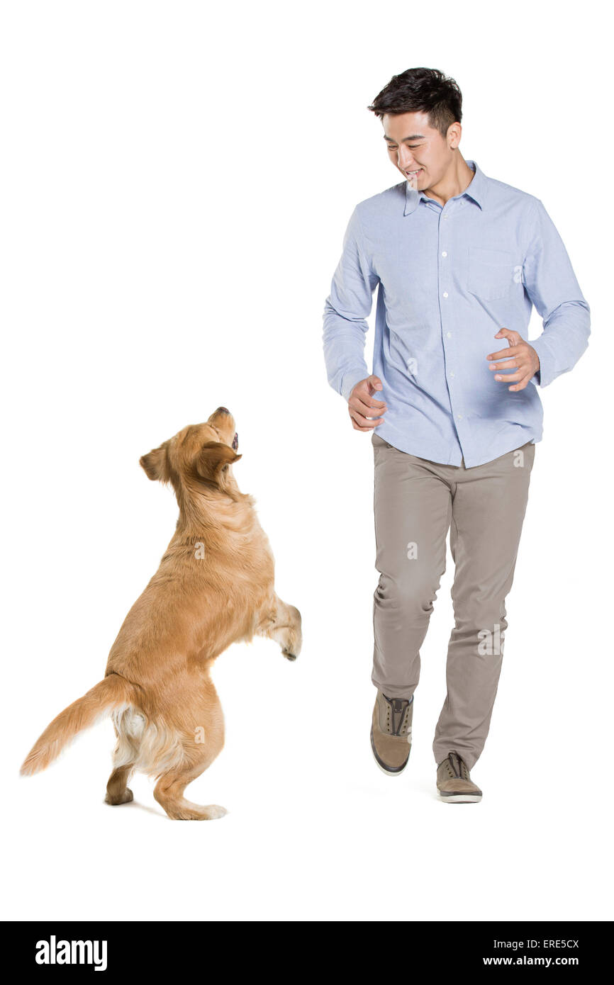 Young man and golden retriever Stock Photo - Alamy