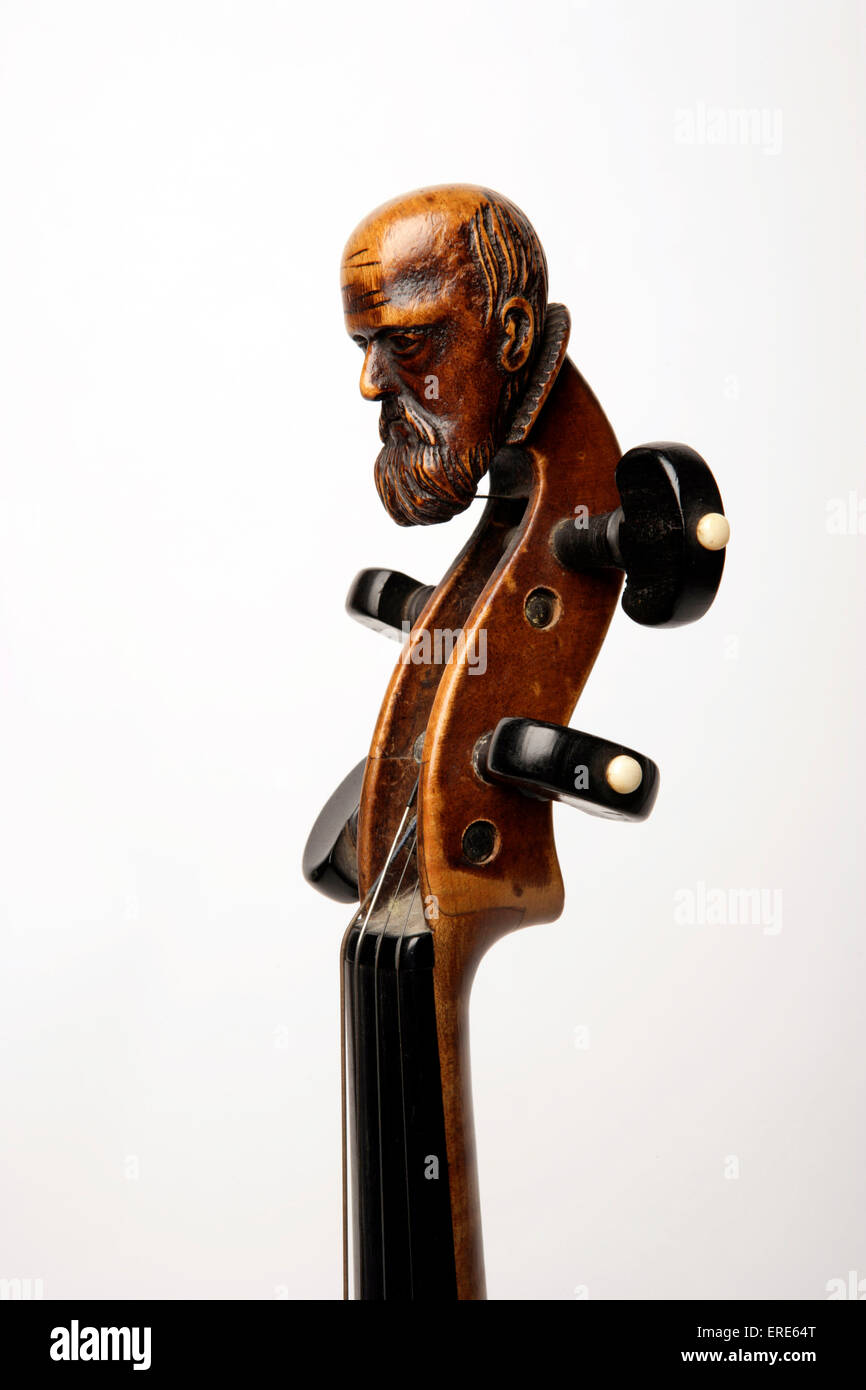 Carved head at the top of a violin scroll. Violin labelled ...