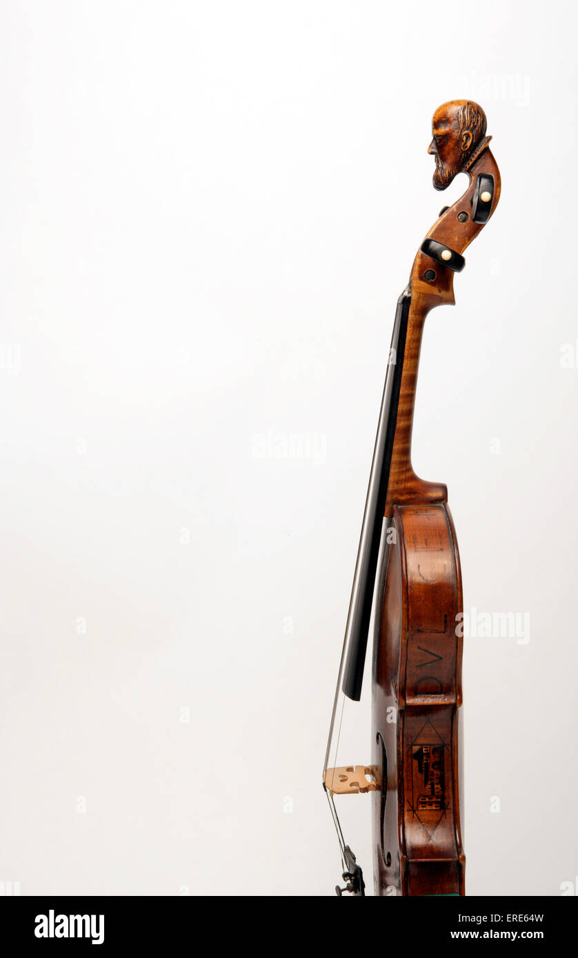 Carved head at the top of a violin scroll. Violin labelled ...