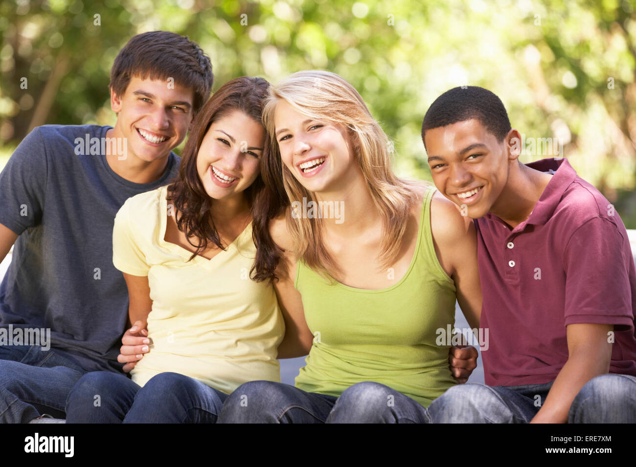 Four Teenage Friends Sitting On Trampoline In Garden Stock Photo - Alamy