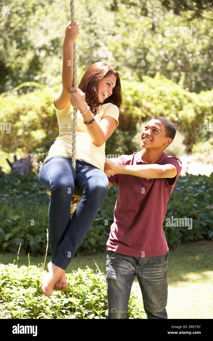 Teenage Couple Having Fun On Rope Swing Stock Photo - Alamy