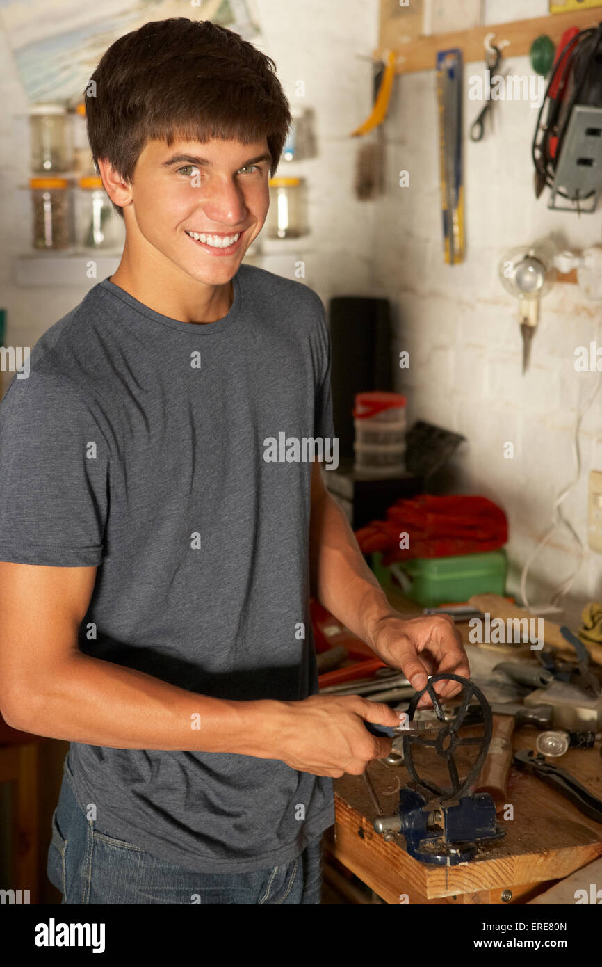 Teenage Boy Using Workbench In Garage Stock Photo - Alamy