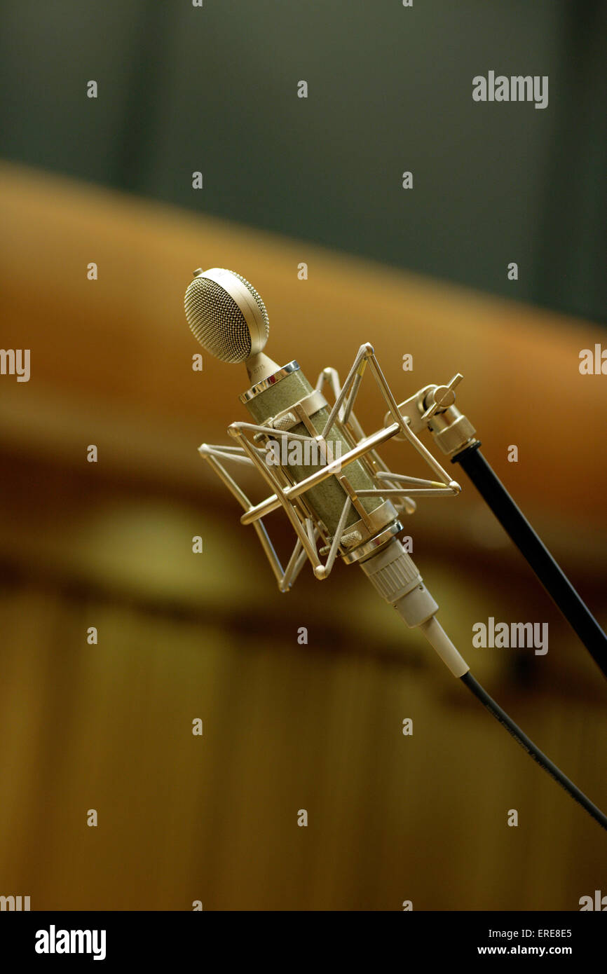 Neumann analogue microphone hanging in a shock mount suspension cradle ...