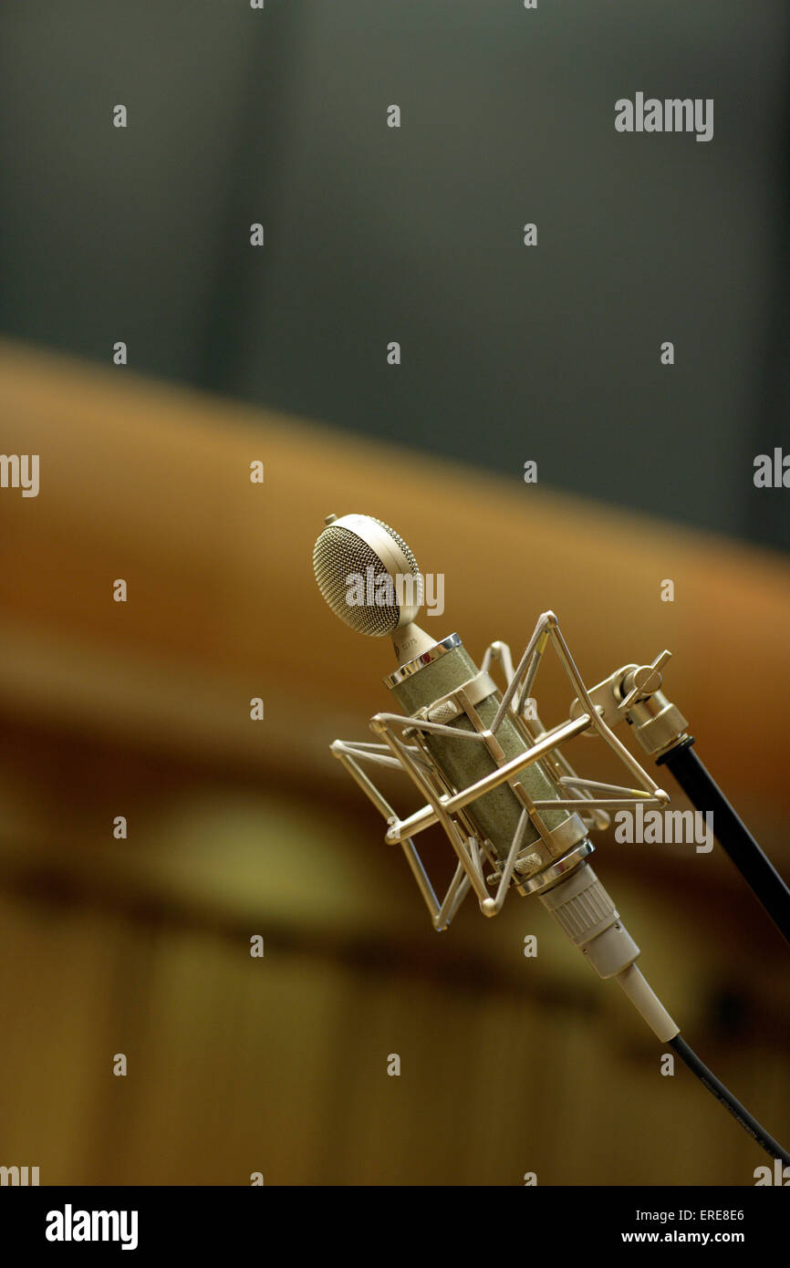Neumann analogue microphone hanging in a shock mount suspension cradle ...