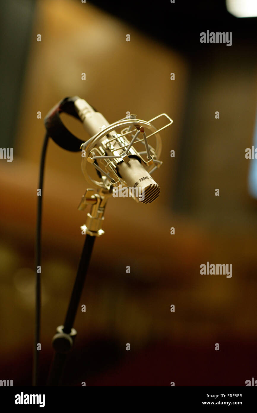 Neumann analogue microphone hanging in a shock mount suspension cradle ...