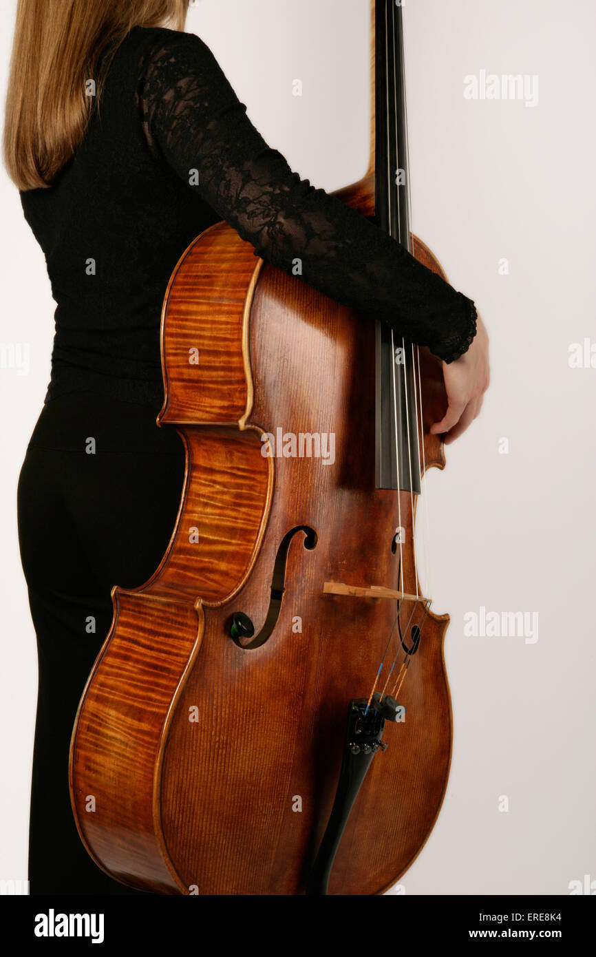 Young woman in concert black, holding her cello Stock Photo - Alamy