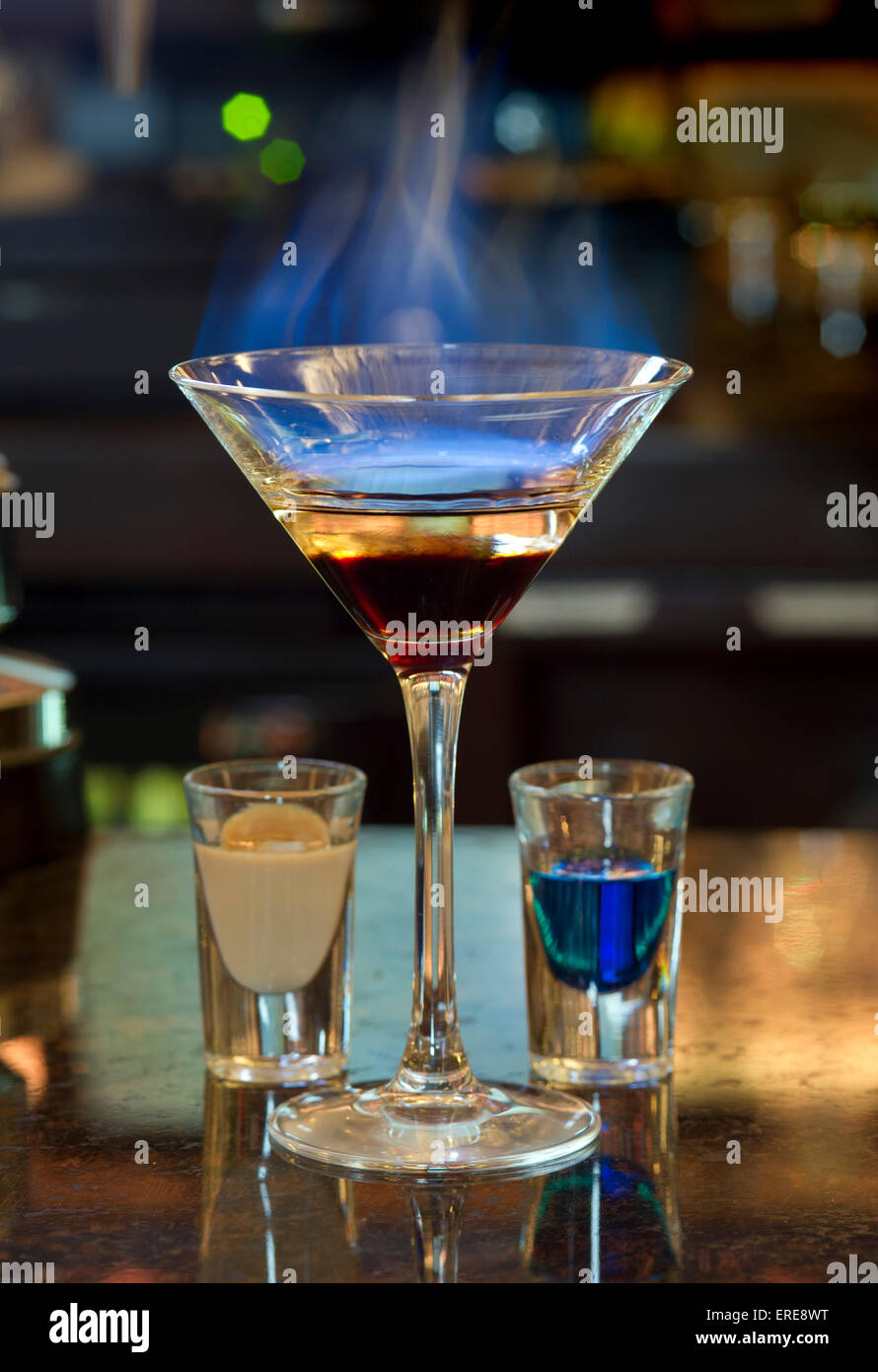 A flaming cocktail on a bar top.a UK drink drinks drinking alcohol ...