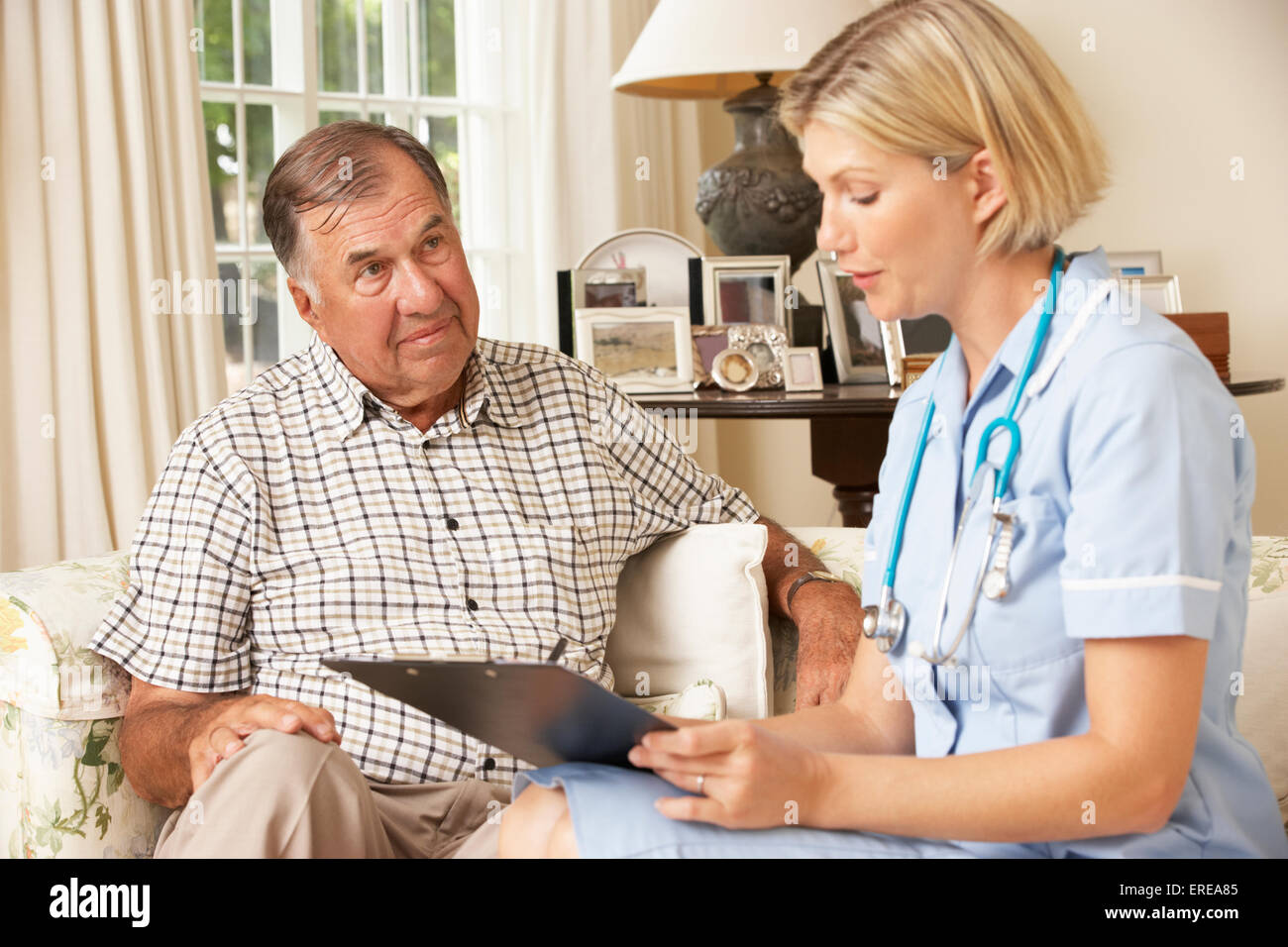 Retired Senior Man Having Health Check With Nurse At Home Stock Photo ...