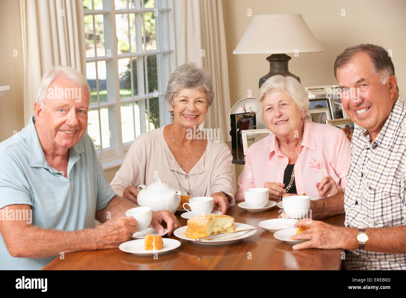 Group Of Senior Couples Enjoying Afternoon Tea Together At Home Stock ...
