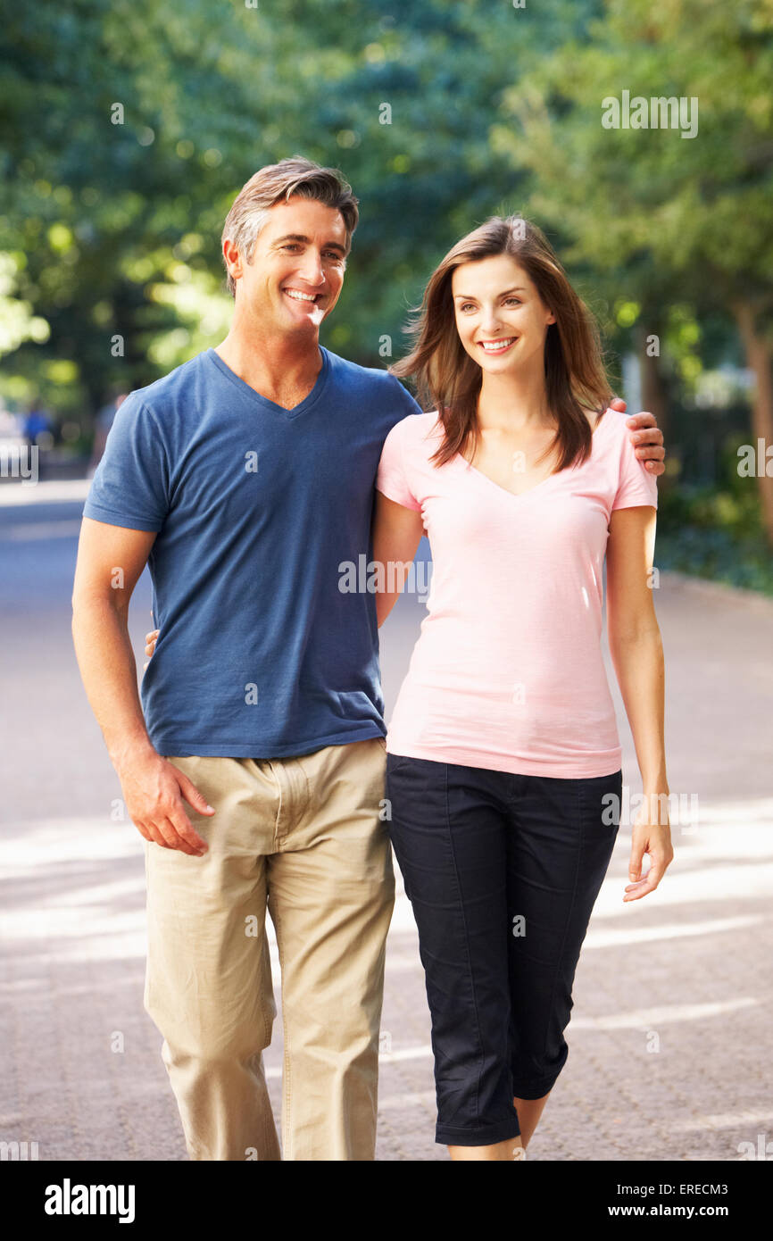 Romantic Couple Walking Through Summer Park Stock Photo - Alamy