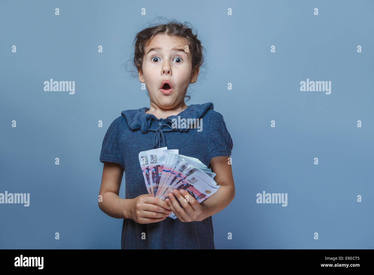 Teen Girl Of European Appearance Holds Five Denominations Of Mon Stock