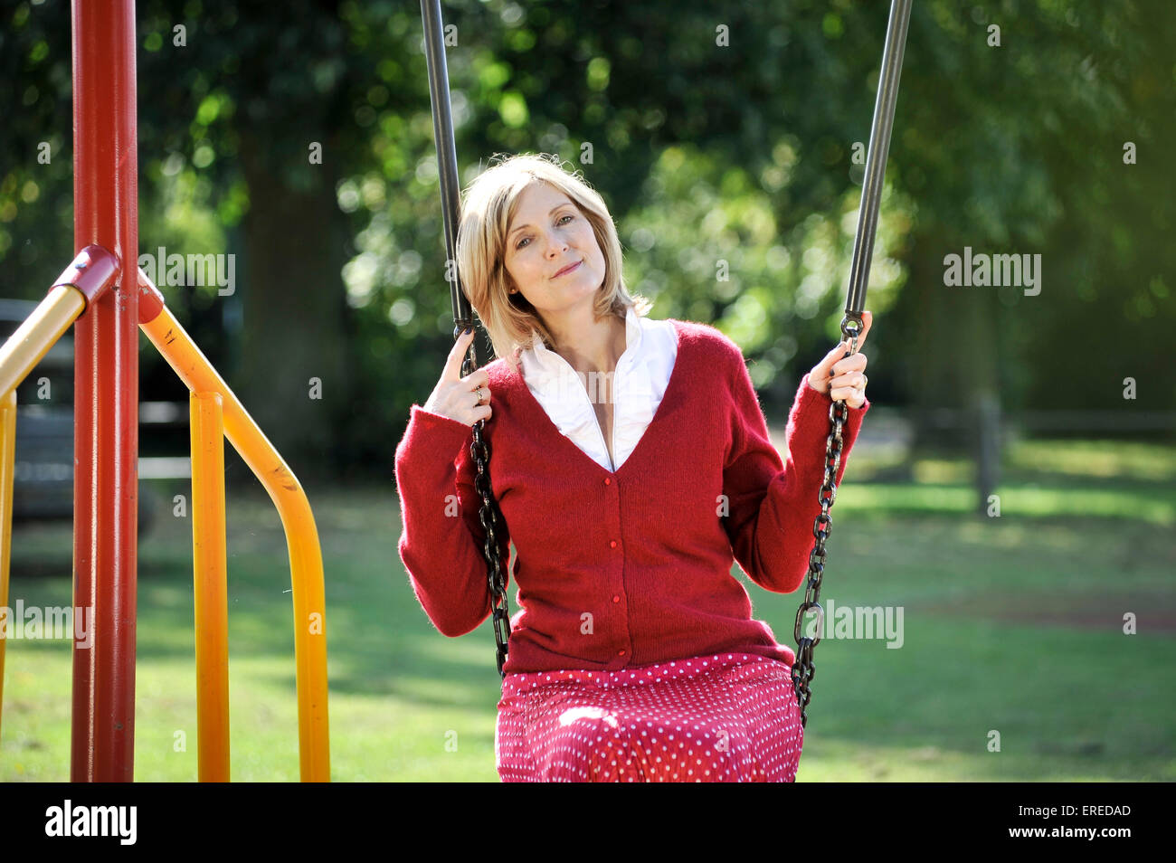 Lady on garden swing seat hi-res stock photography and images - Alamy