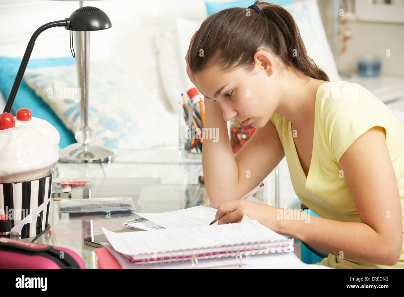 Teenage Girl Studying At Desk In Bedroom Stock Photo - Alamy