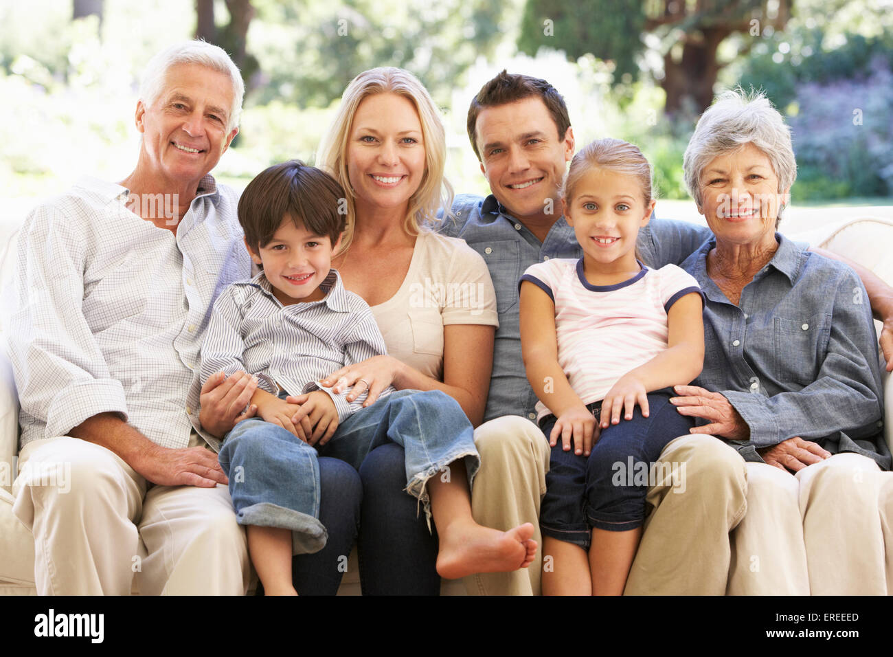 Three Generation Family Sitting On Sofa At Home Stock Photo - Alamy