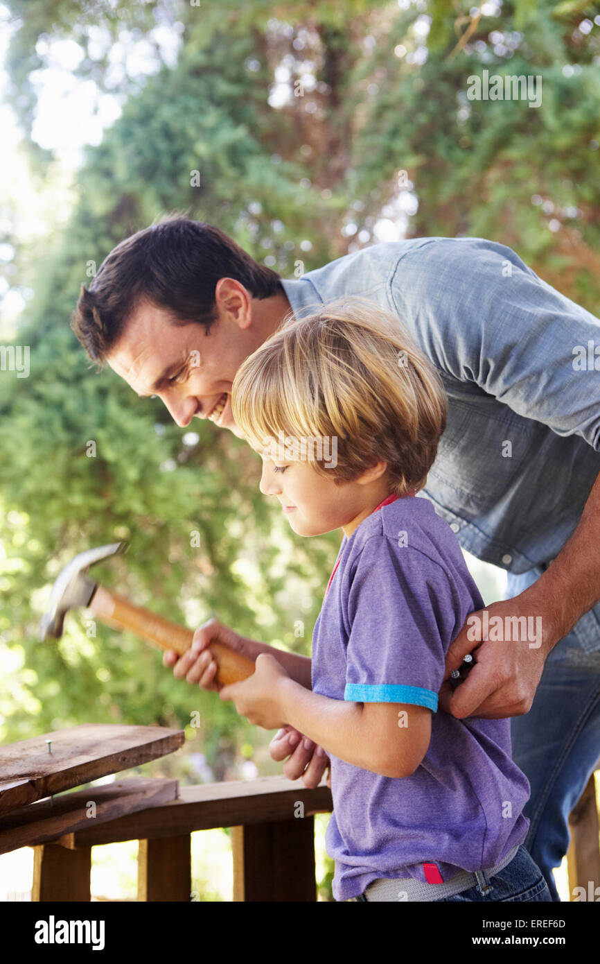 Father And Son Building Tree House Together Stock Photo - Alamy