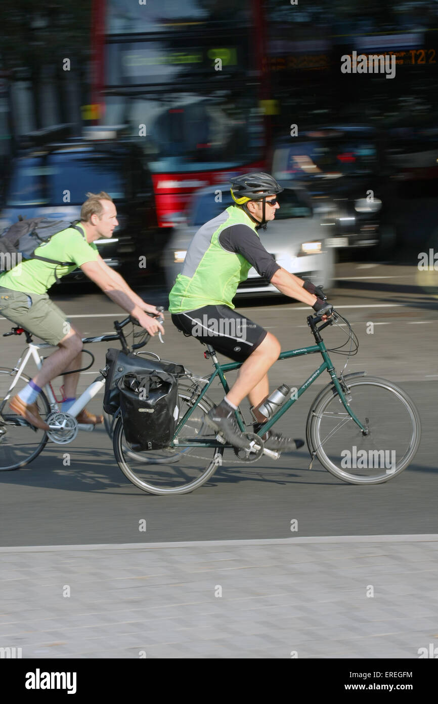 Two cyclists traveling in Trafalgar Square, London, England Stock Photo ...