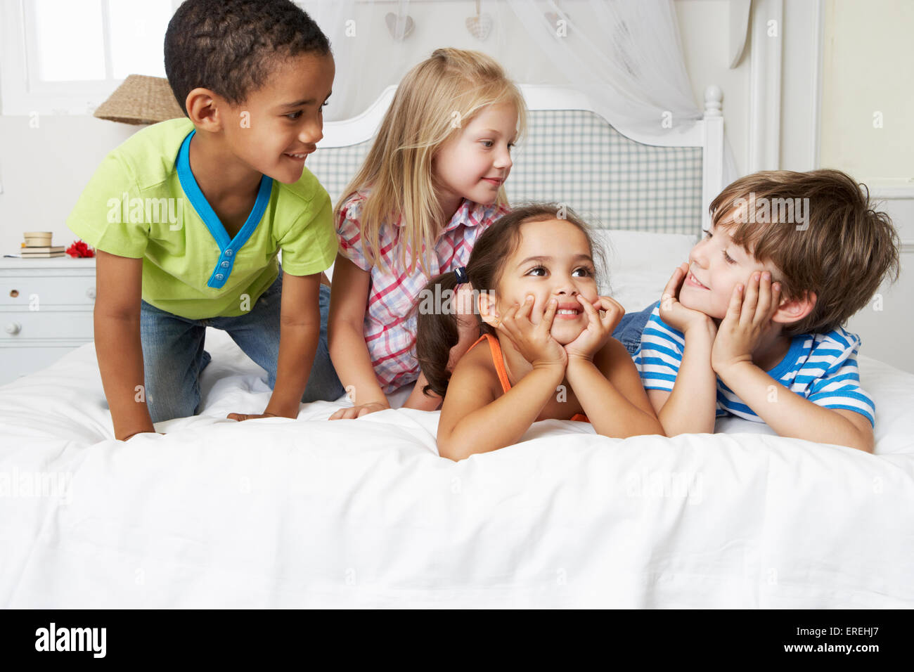 Four Children Playing On Bed Together Stock Photo - Alamy