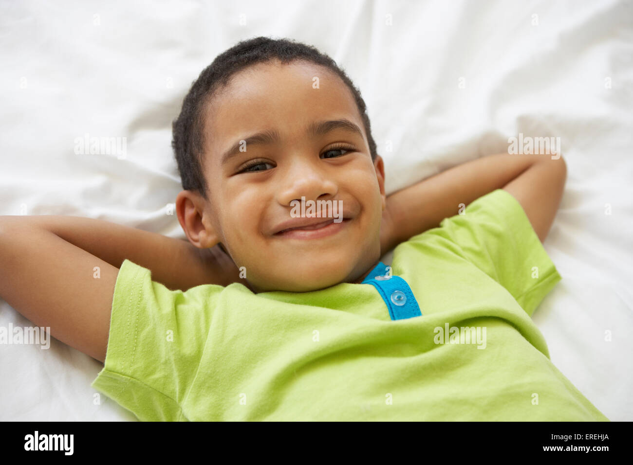 Young Boys Relaxing On Bed Stock Photo - Alamy