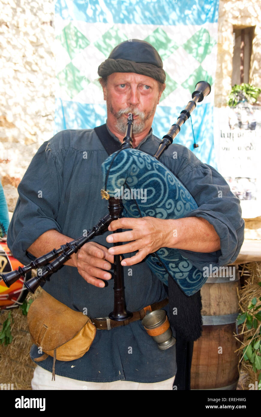 Man in medieval costume playing Galician bagpipes, in the village of ...