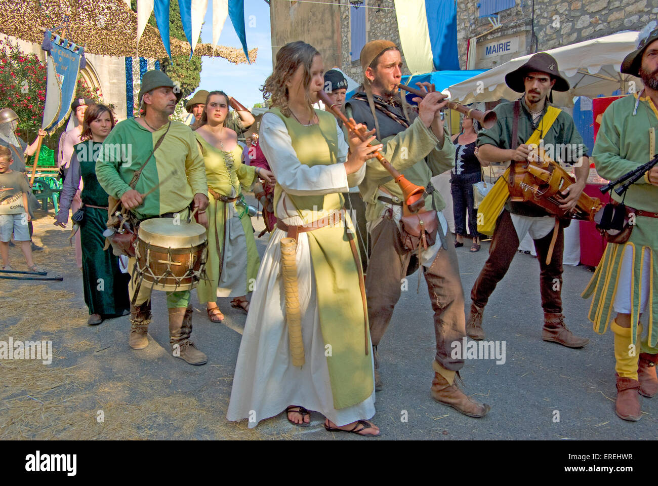 Musicians in medieval costumes, playing tabor, shawms and hurdy-gurdy ...