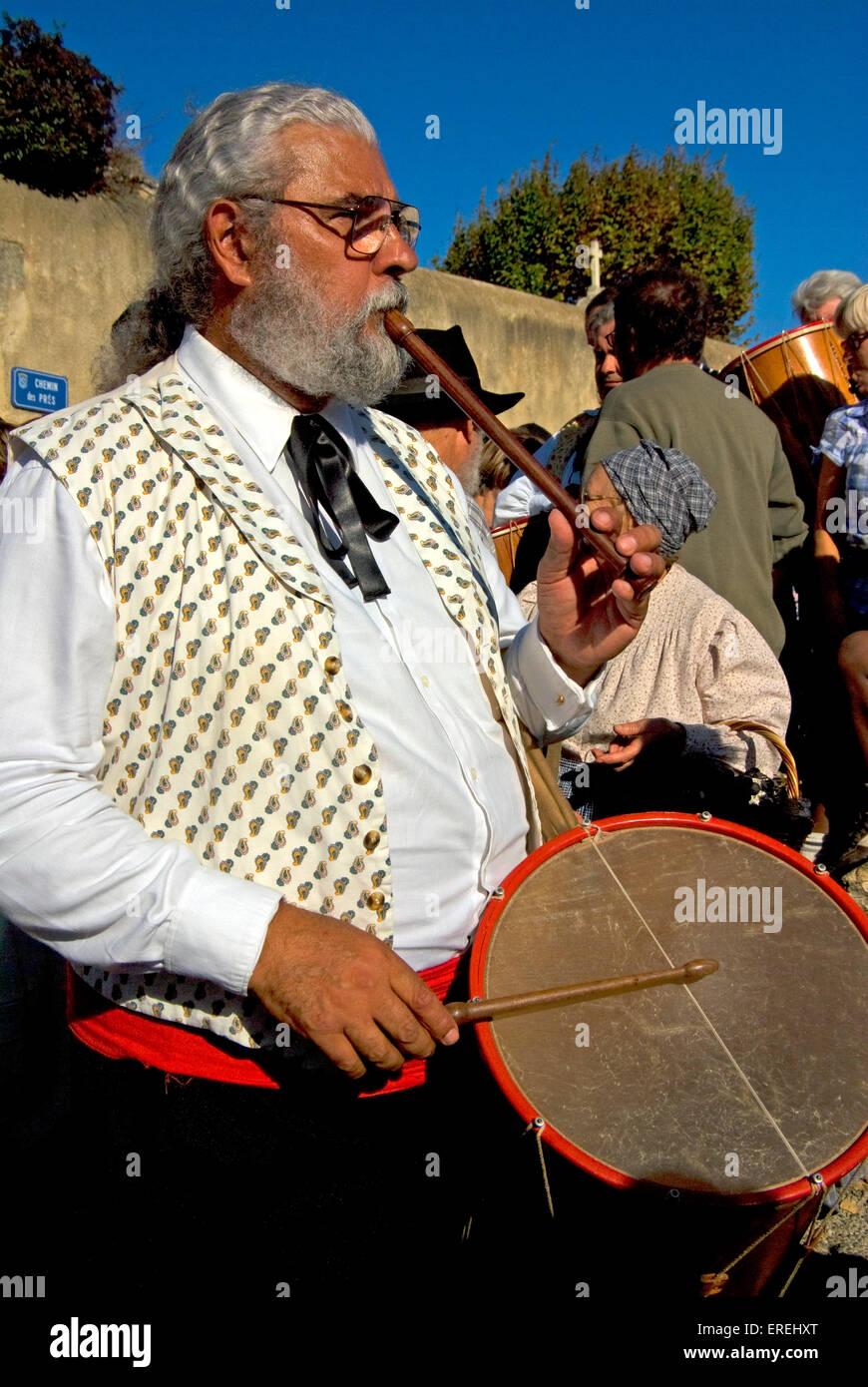 Man in local costume playing tambourin (tabor) and galoubet (three-hole ...