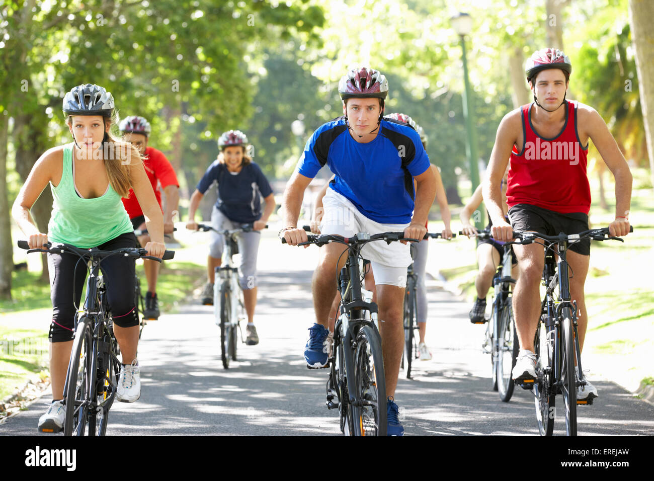 Group Of Cyclists On Cycle Ride Through Park Stock Photo - Alamy