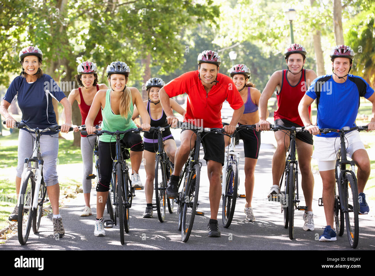 Group Of Cyclists On Cycle Ride Through Park Stock Photo - Alamy