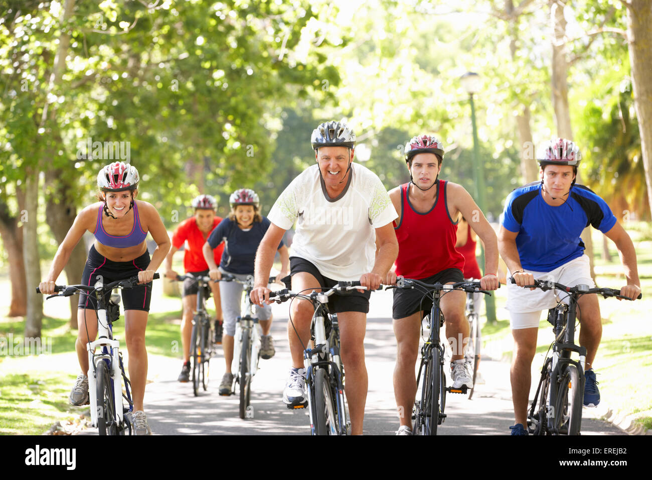 Group Of Cyclists On Cycle Ride Through Park Stock Photo - Alamy