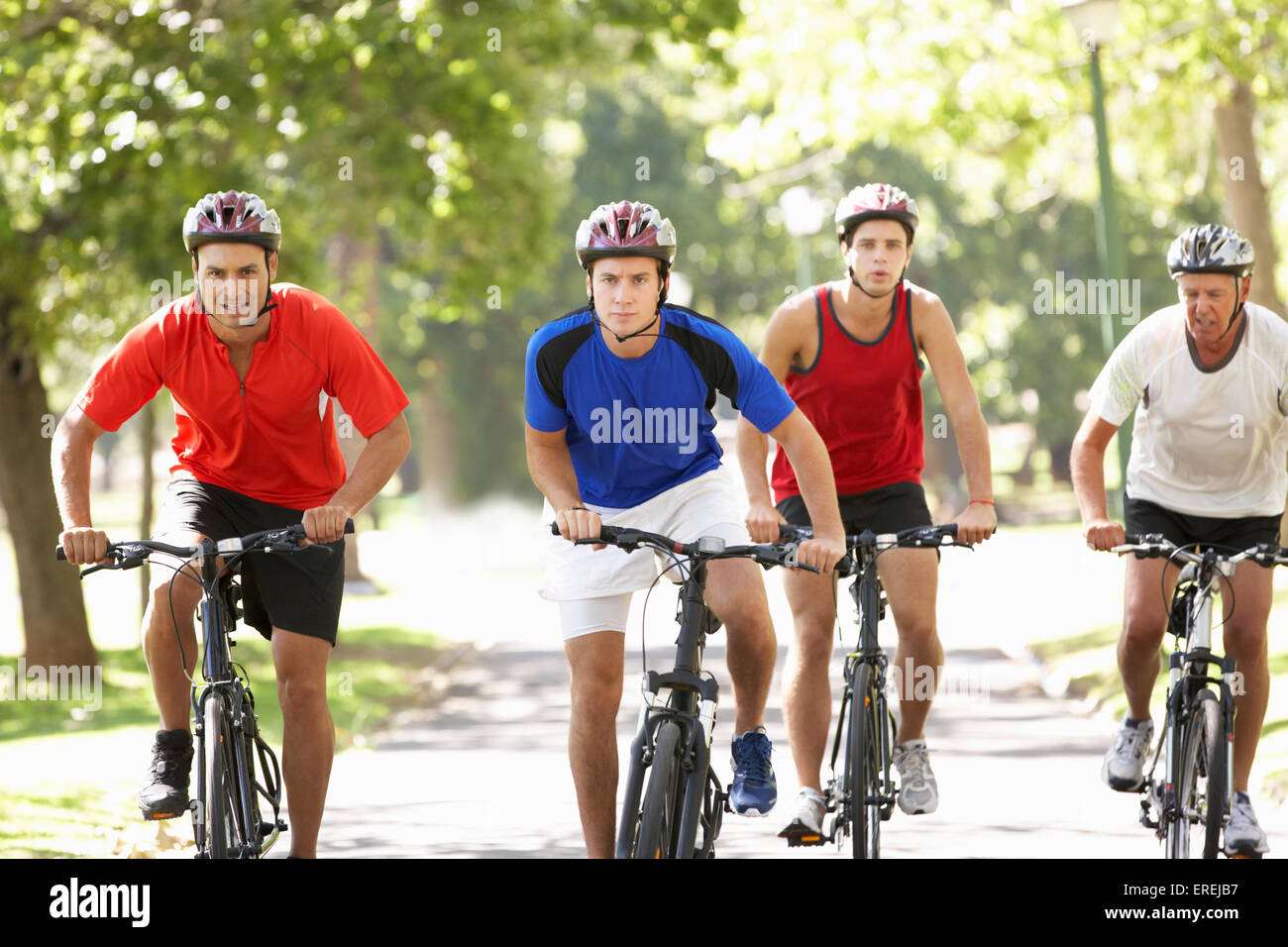 Group Of Men On Cycle Ride Through Park Stock Photo - Alamy