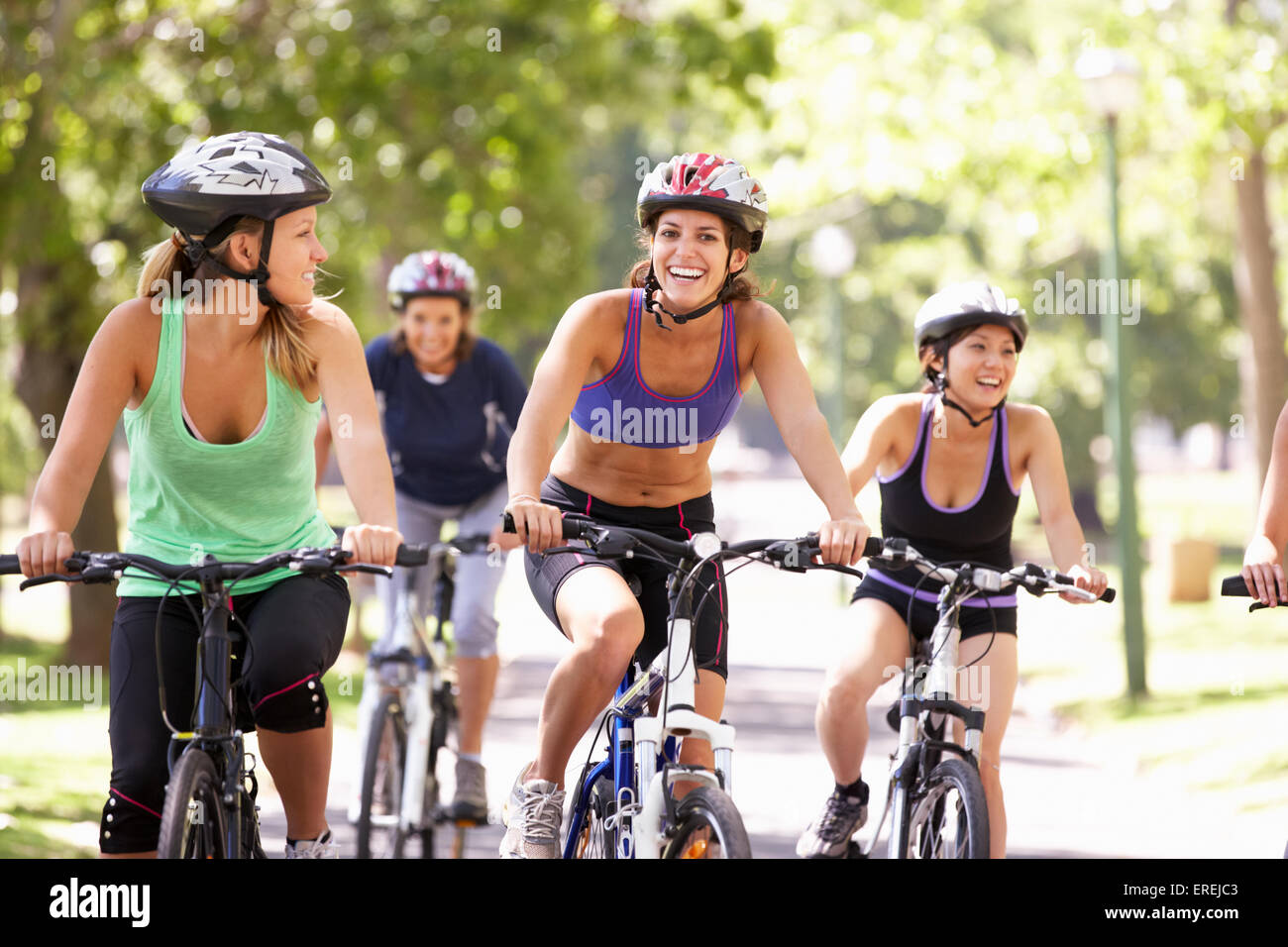 Group Of Women On Cycle Ride Through Park Stock Photo - Alamy