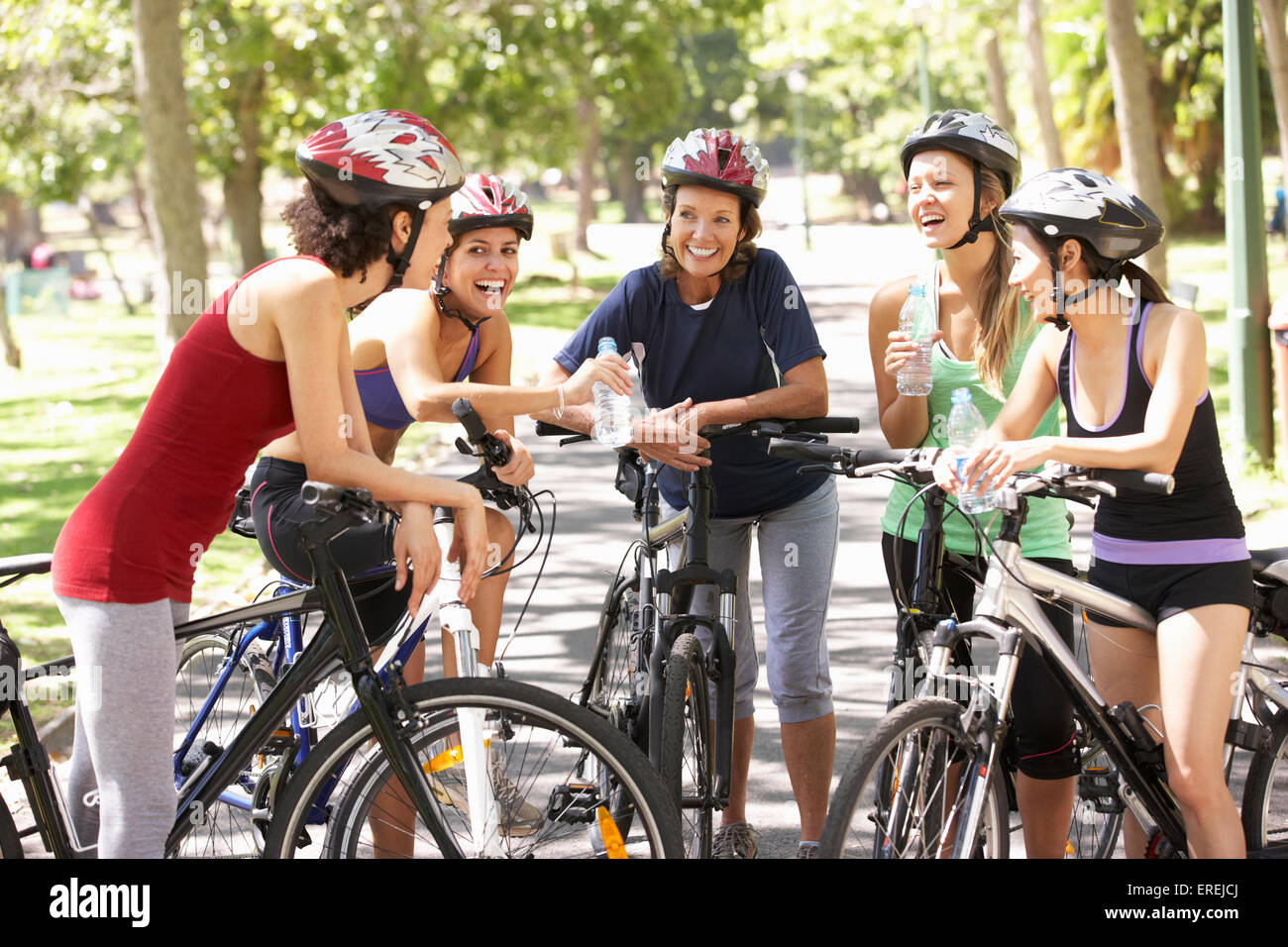Group Of Women Resting During Cycle Ride Through Park Stock Photo - Alamy