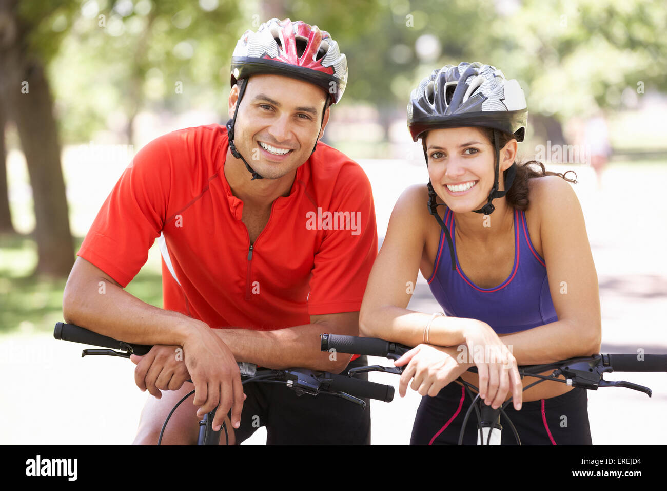 Portrait Of Couple On Cycle Ride Through Park Stock Photo - Alamy
