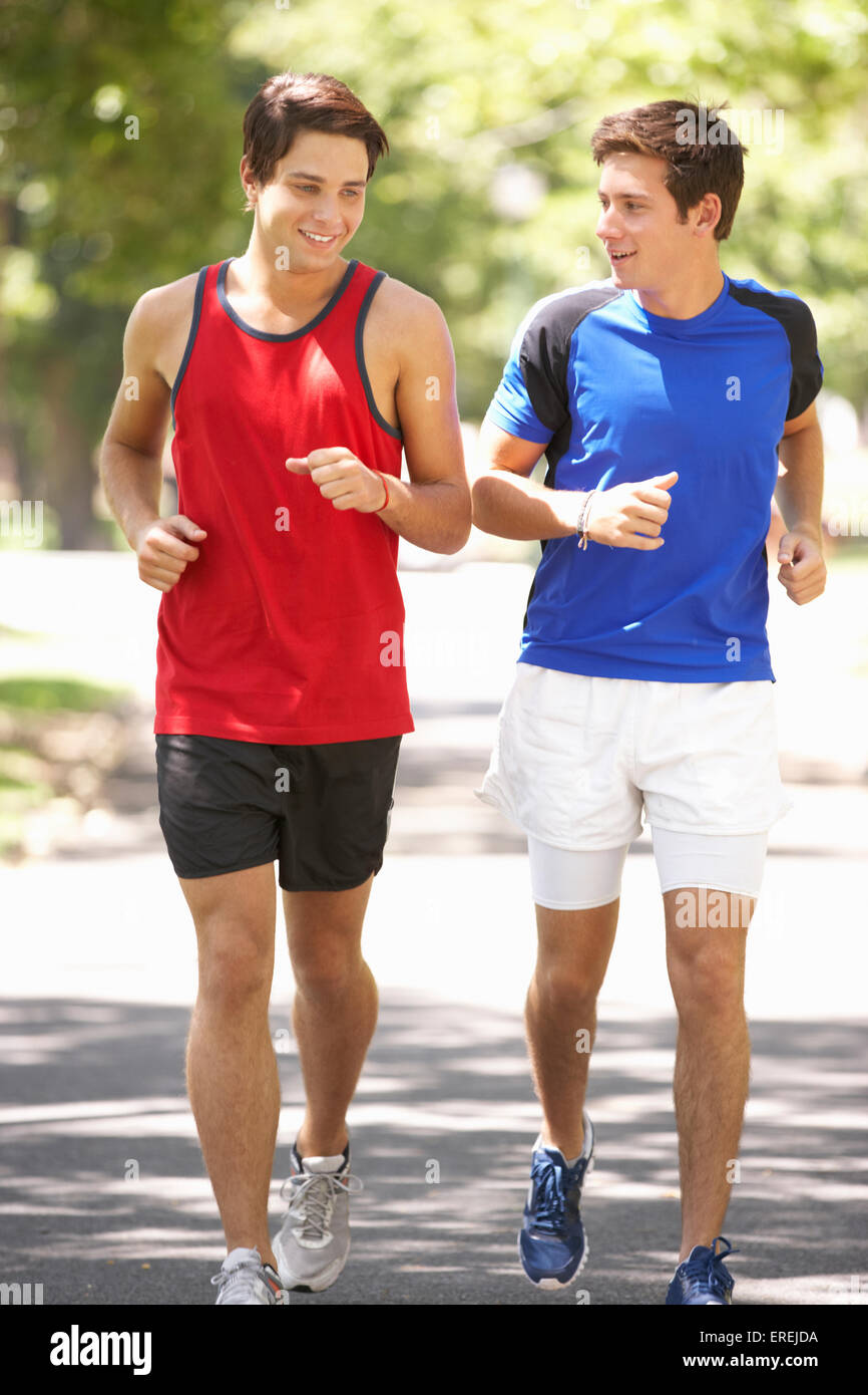 Two Men Running Through Park Stock Photo - Alamy