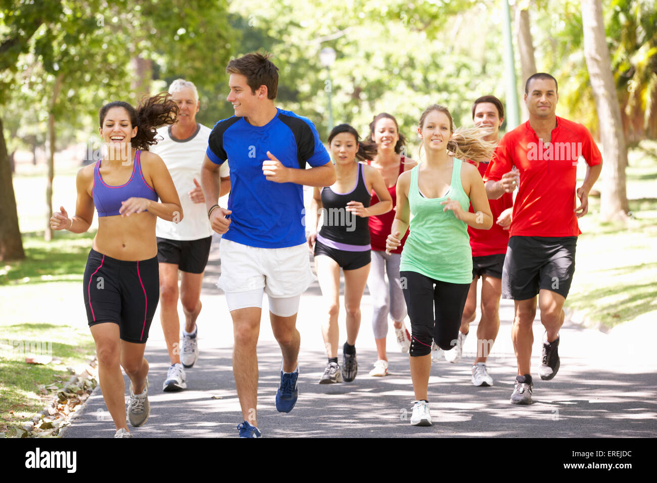 Group Of Runners Jogging Through Park Stock Photo - Alamy