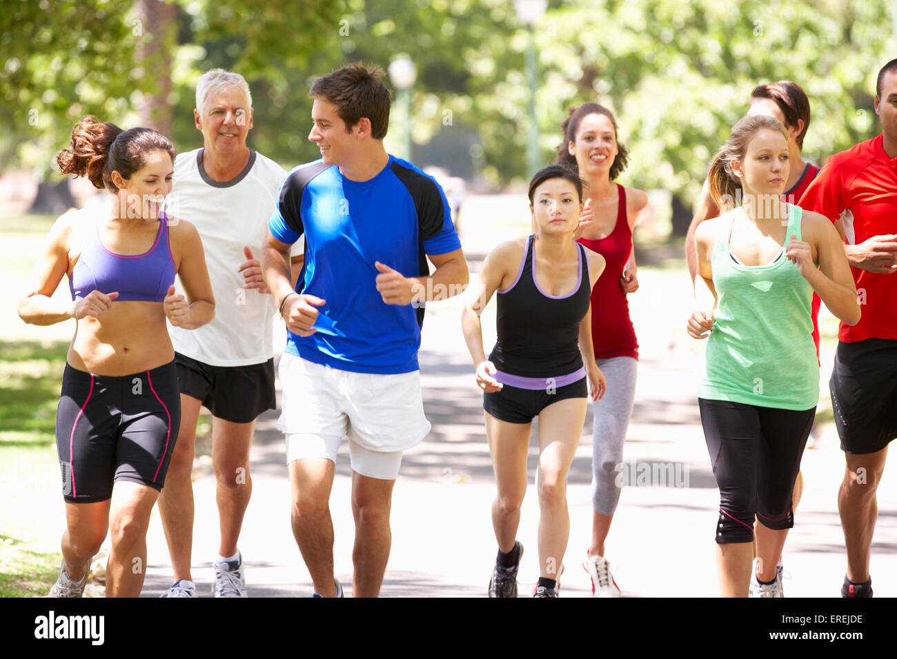 Group Of Runners Jogging Through Park Stock Photo - Alamy