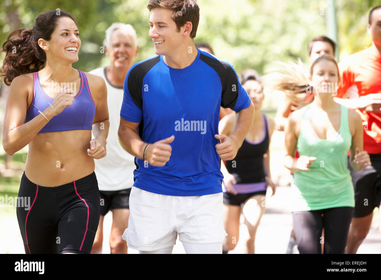 Group Of Runners Jogging Through Park Stock Photo - Alamy