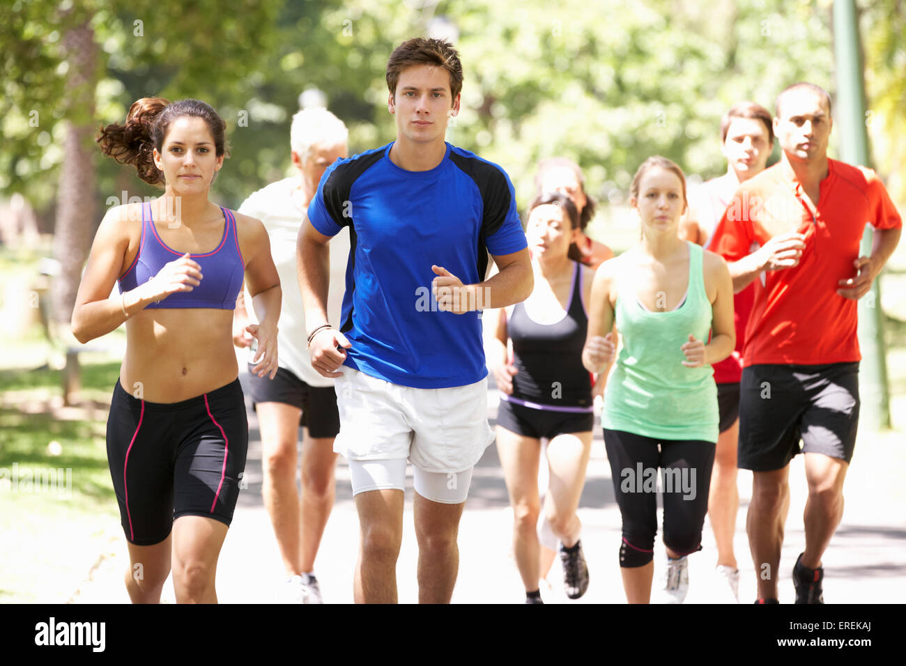 Group Of Runners Jogging Through Park Stock Photo - Alamy