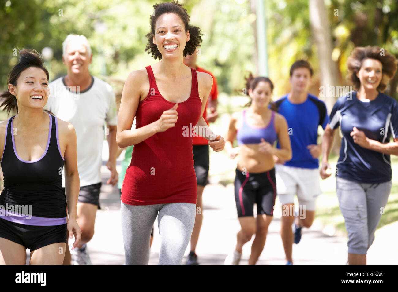Group Of Runners Jogging Through Park Stock Photo - Alamy